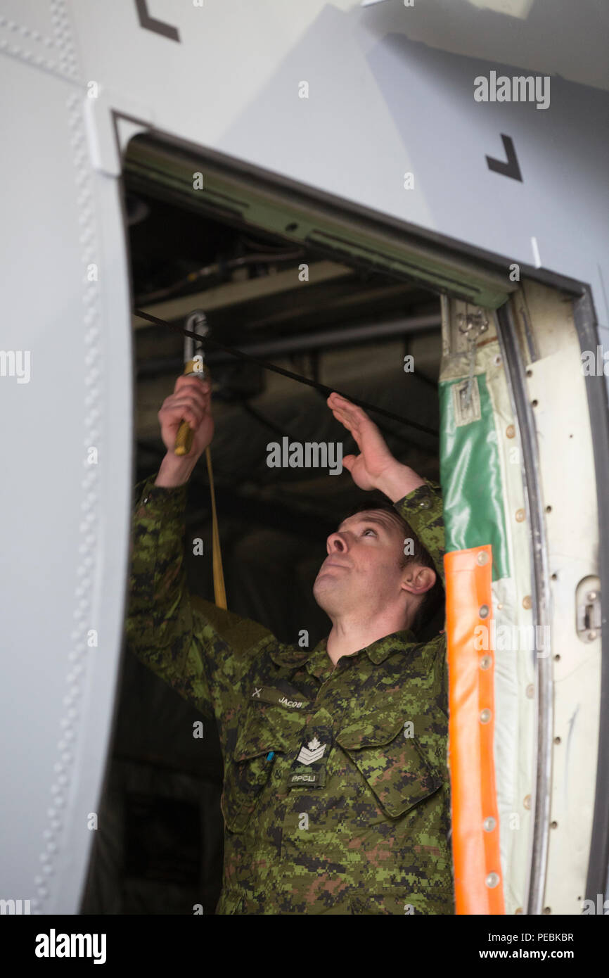 A Canadian Jumpmaster hooks his static line during Jumpmaster Aircraft ...