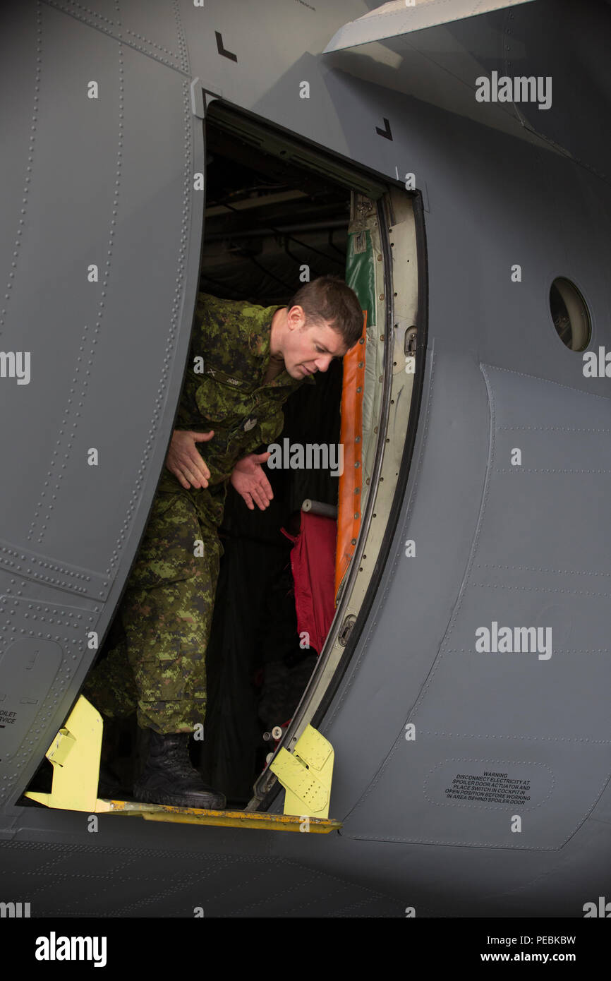 A Canadian Jumpmaster simulates exiting the door of a C-130 Hercules ...