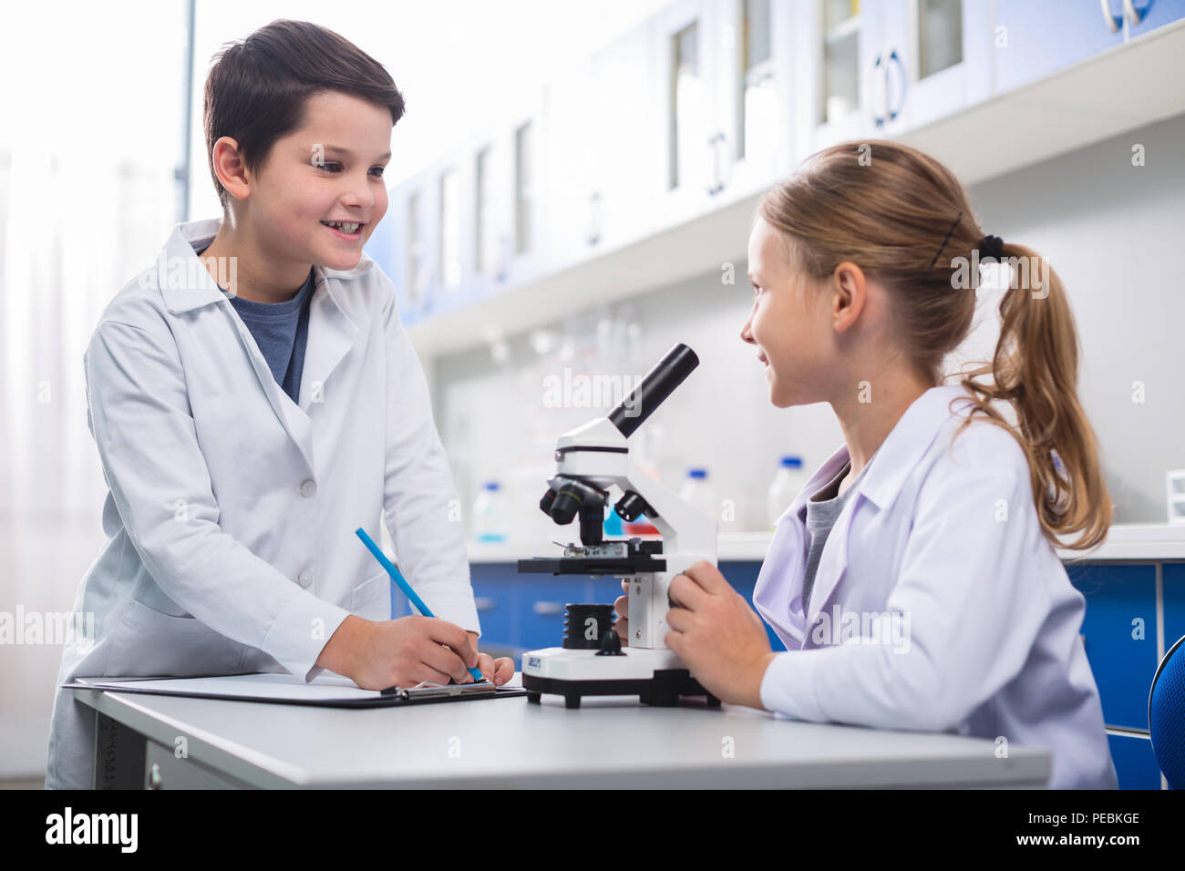 Our observation. Nice positive delighted boy looking at his friend and ...