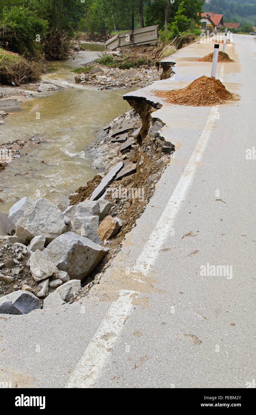 Destroyed road after natural disaster of river flooding Stock Photo - Alamy