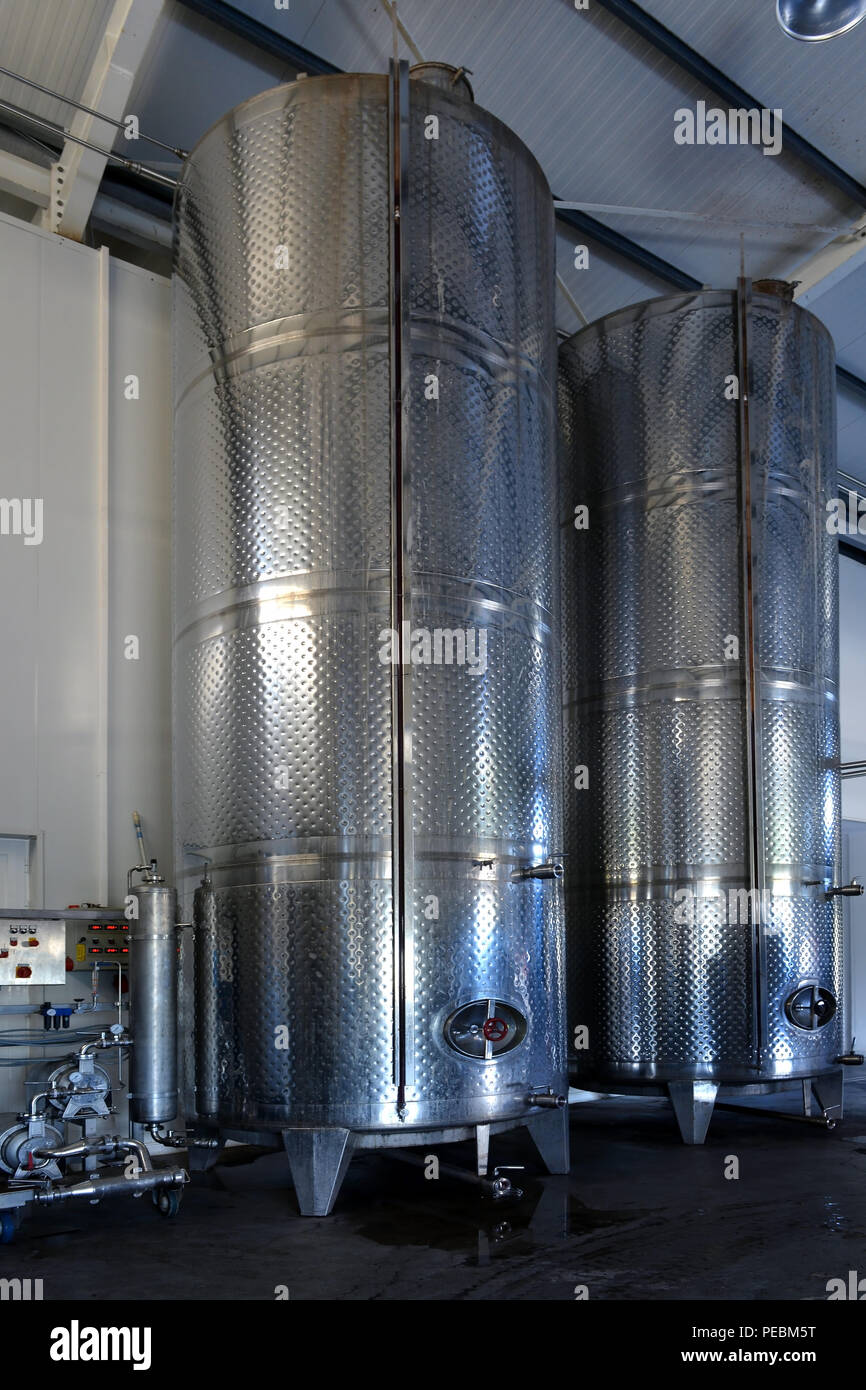 Stainless steel wine vats in a row inside the winery Stock Photo - Alamy