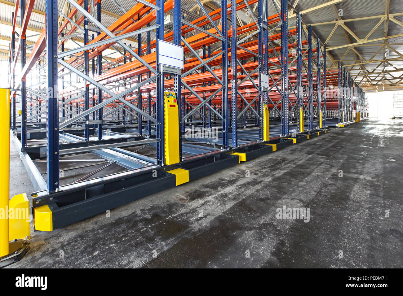 Mobile roller shelving system in distribution warehouse Stock Photo - Alamy