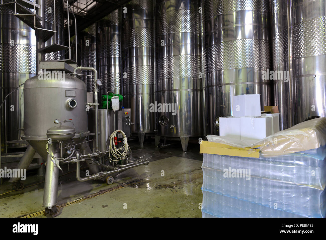 Stainless steel wine vats in a row inside the winery Stock Photo - Alamy