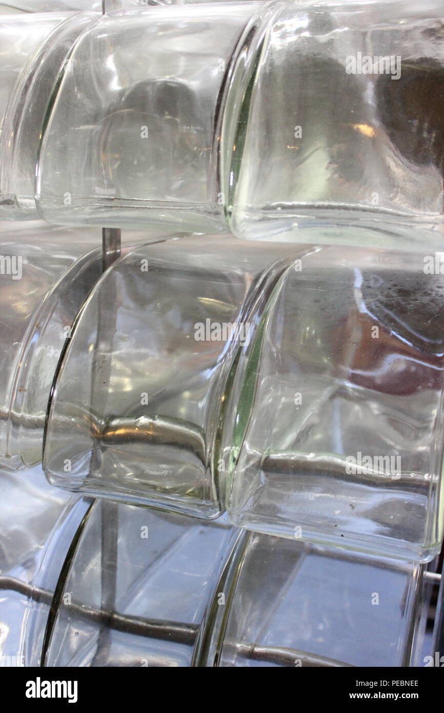 Stacked and empty vintage glass display containers at Architectural ...