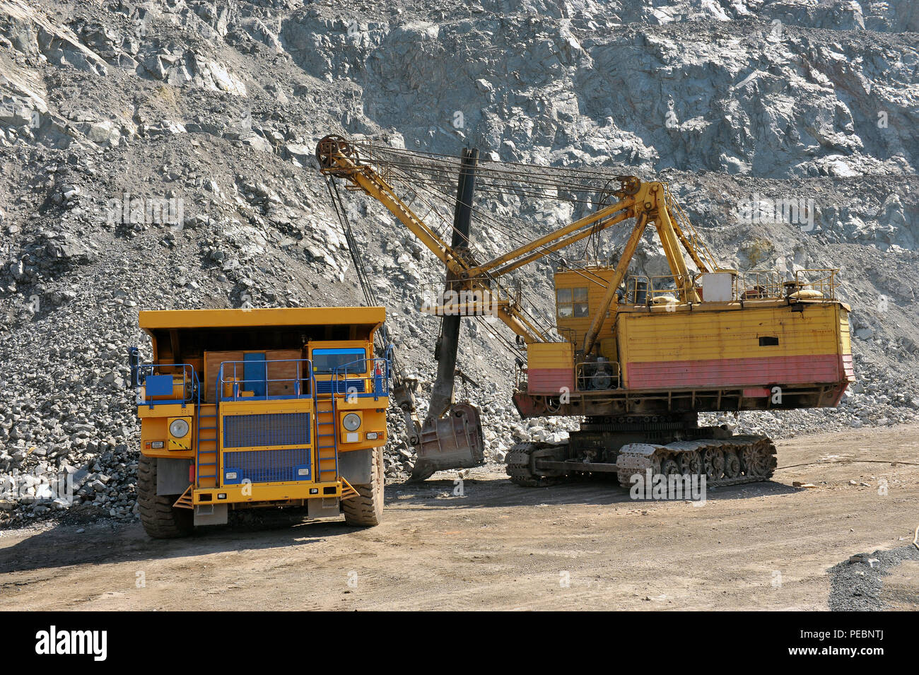 Loading of iron ore on very big dump-body truck Stock Photo - Alamy