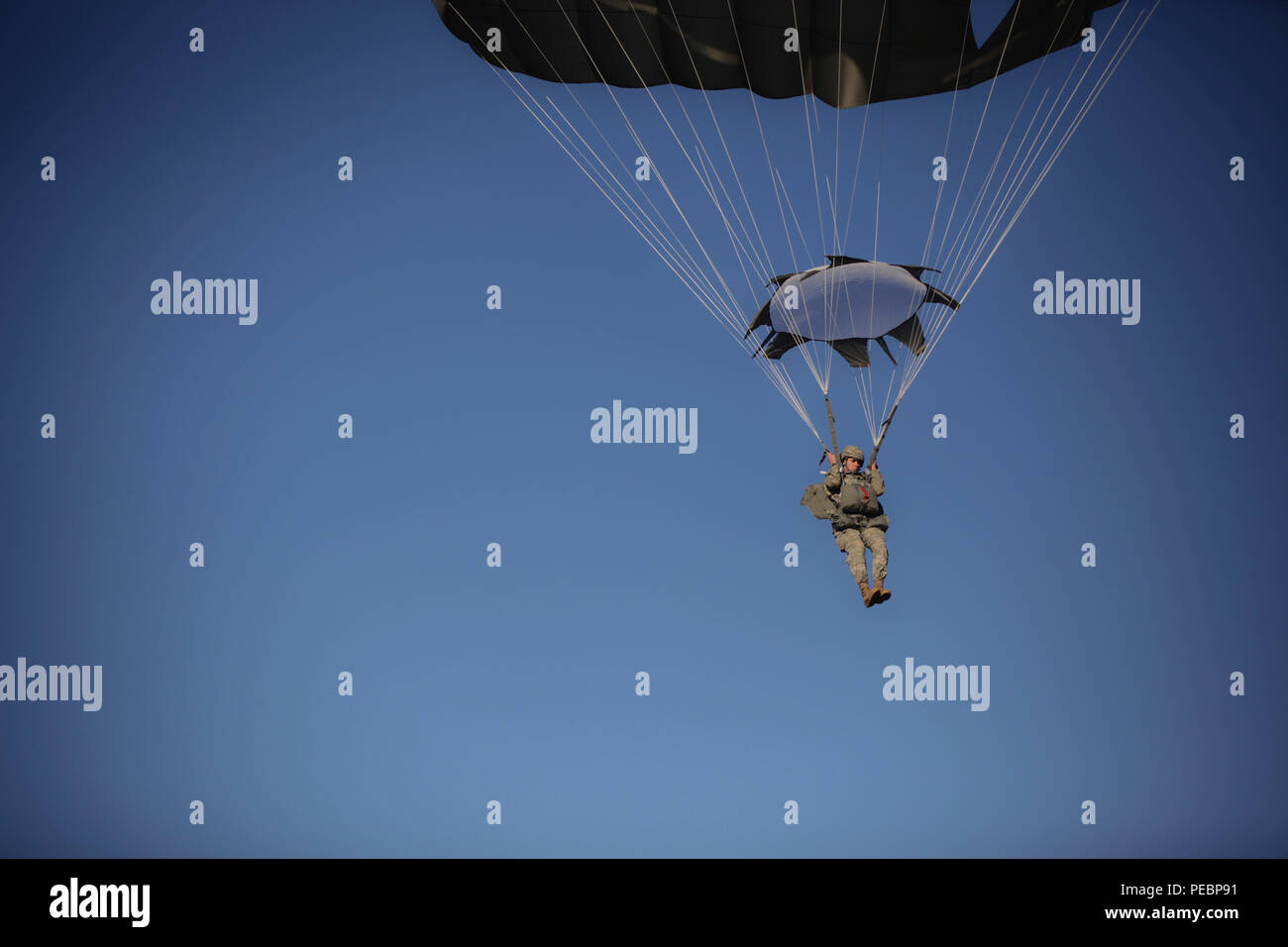 U.S. Army paratrooper prepares to land onto Sicily Drop Zone during ...