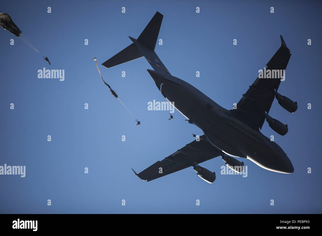 U.S. Army paratroopers exit a C-17 aircraft for an airborne jump onto ...