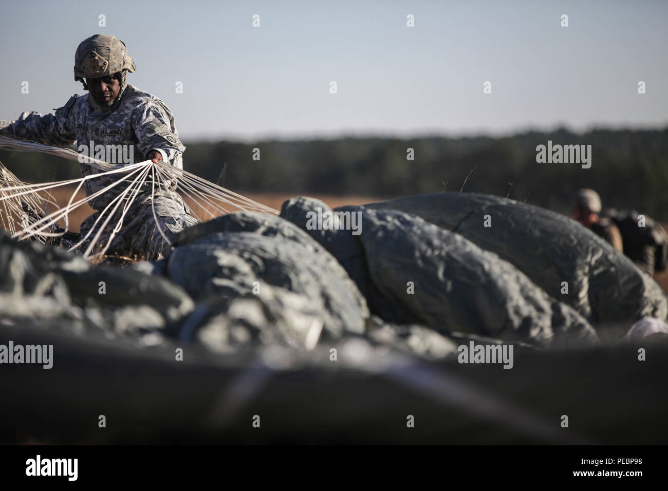 U.S. Army paratrooper recovers his T-11 main parachute after ...