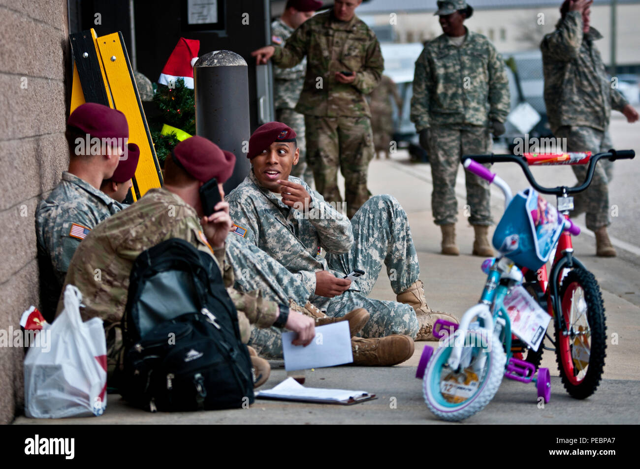 Soldiers wait outside the Green Ramp passenger terminal at Fort Bragg ...