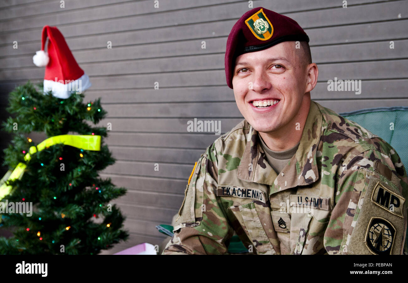 U.S. Army Staff Sgt. Micheal Tkachenko waits in line to donate his toy ...