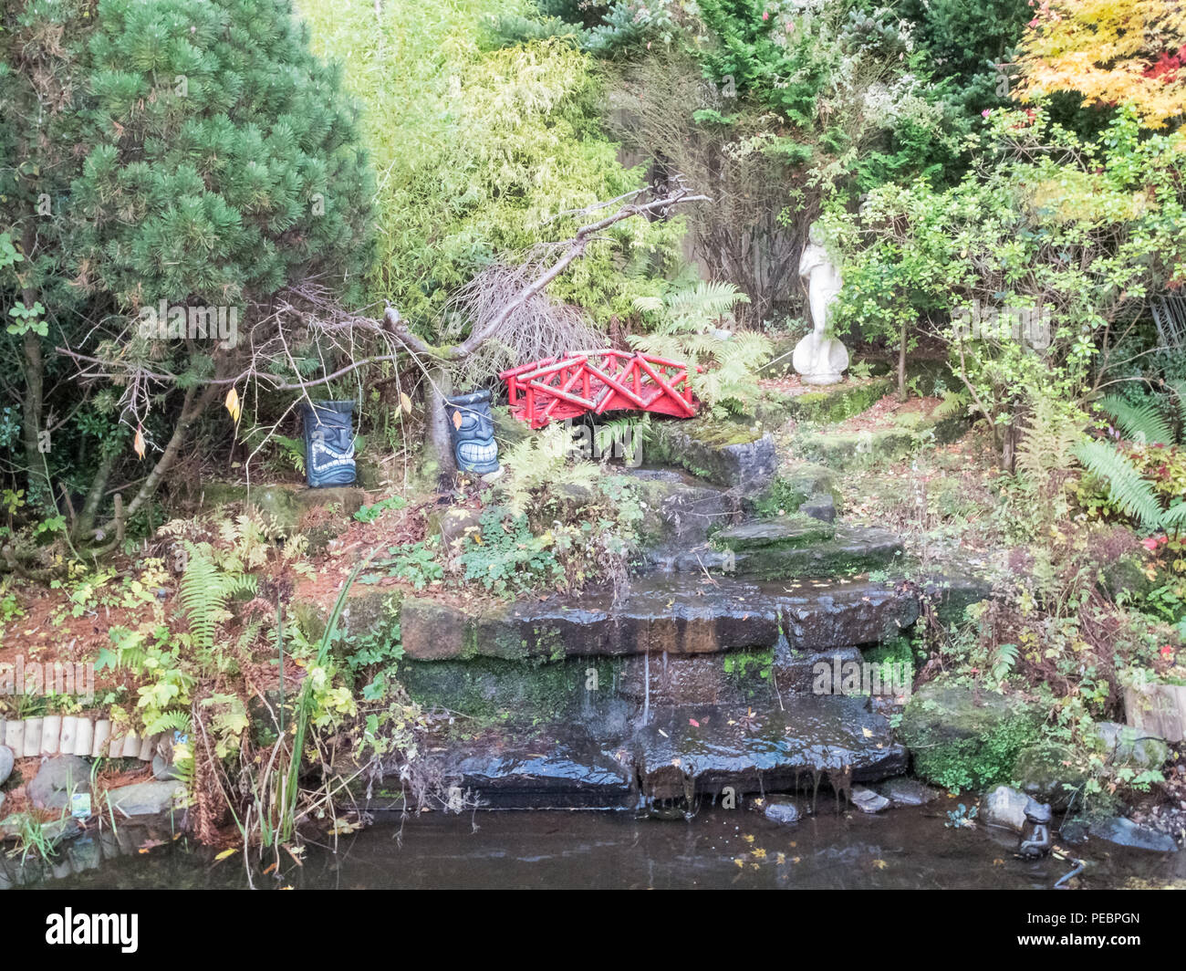 A minature garden waterfall feature with ornaments and running water ...