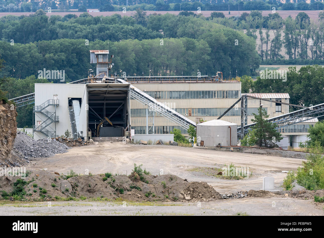 Big silos, belt conveyors and mining equipment in a quarry. Quarrying ...