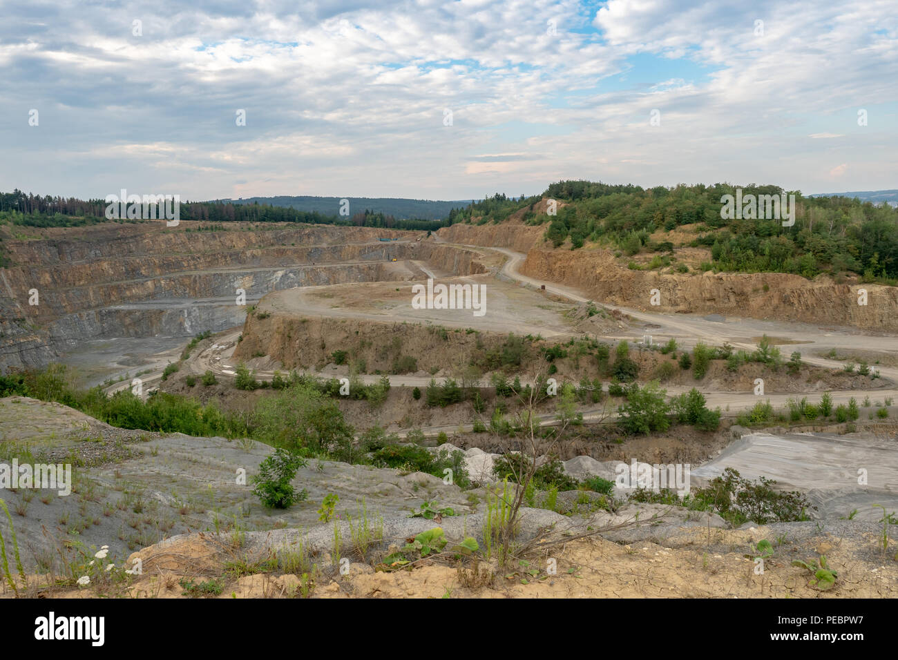 Opencast mining quarry with machinery. Quarrying of stones for ...