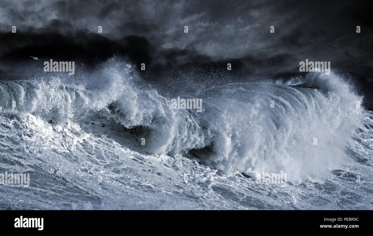 Big Atlantic wave over Portuguese cost. Enhanced sky. toned blue Stock ...