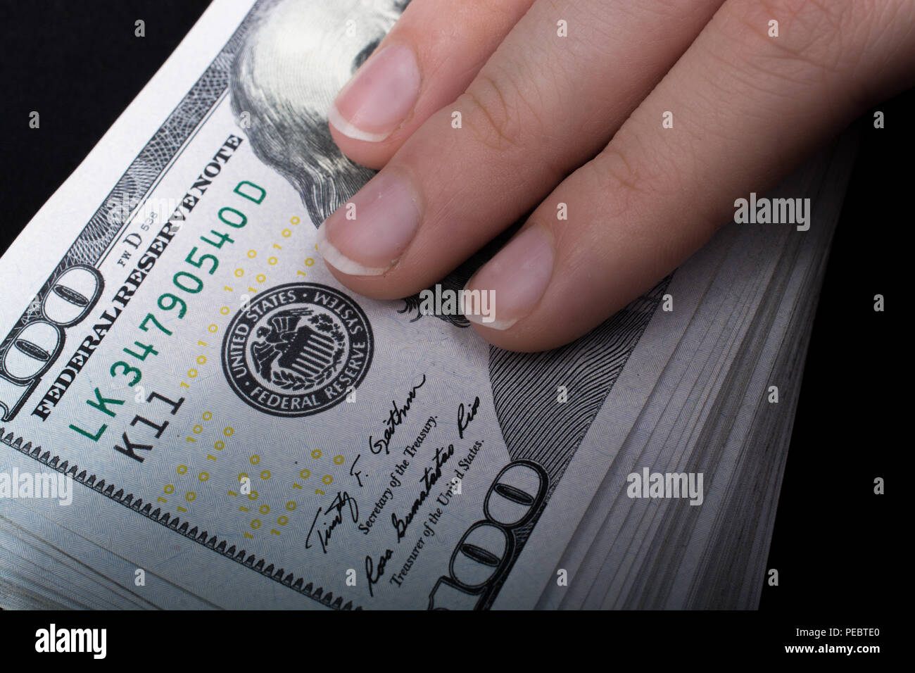 Hand holding American dollar banknotes isolated on white background ...