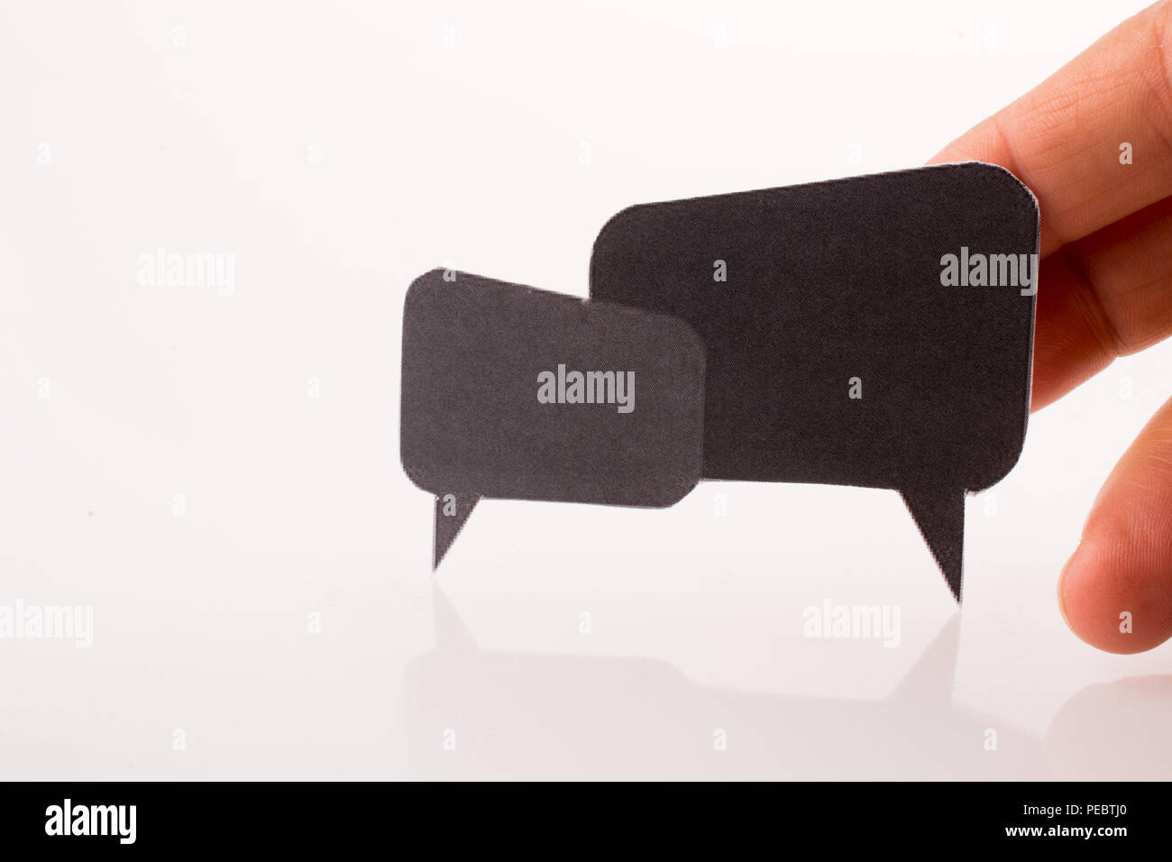 Hand holding dialogue boxes on a white background Stock Photo - Alamy