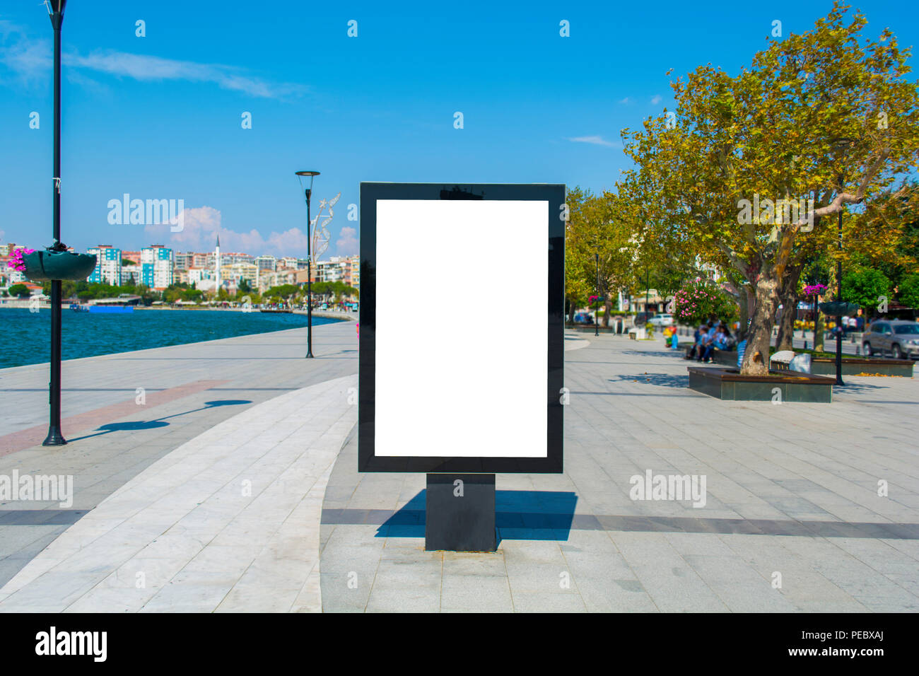Blank mock up of vertical street poster billboard on city background ...