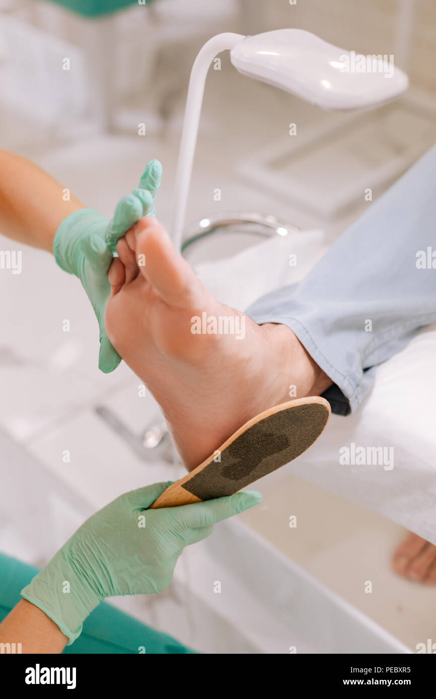 Pedicure master holding feet scrubber while providing service Stock ...