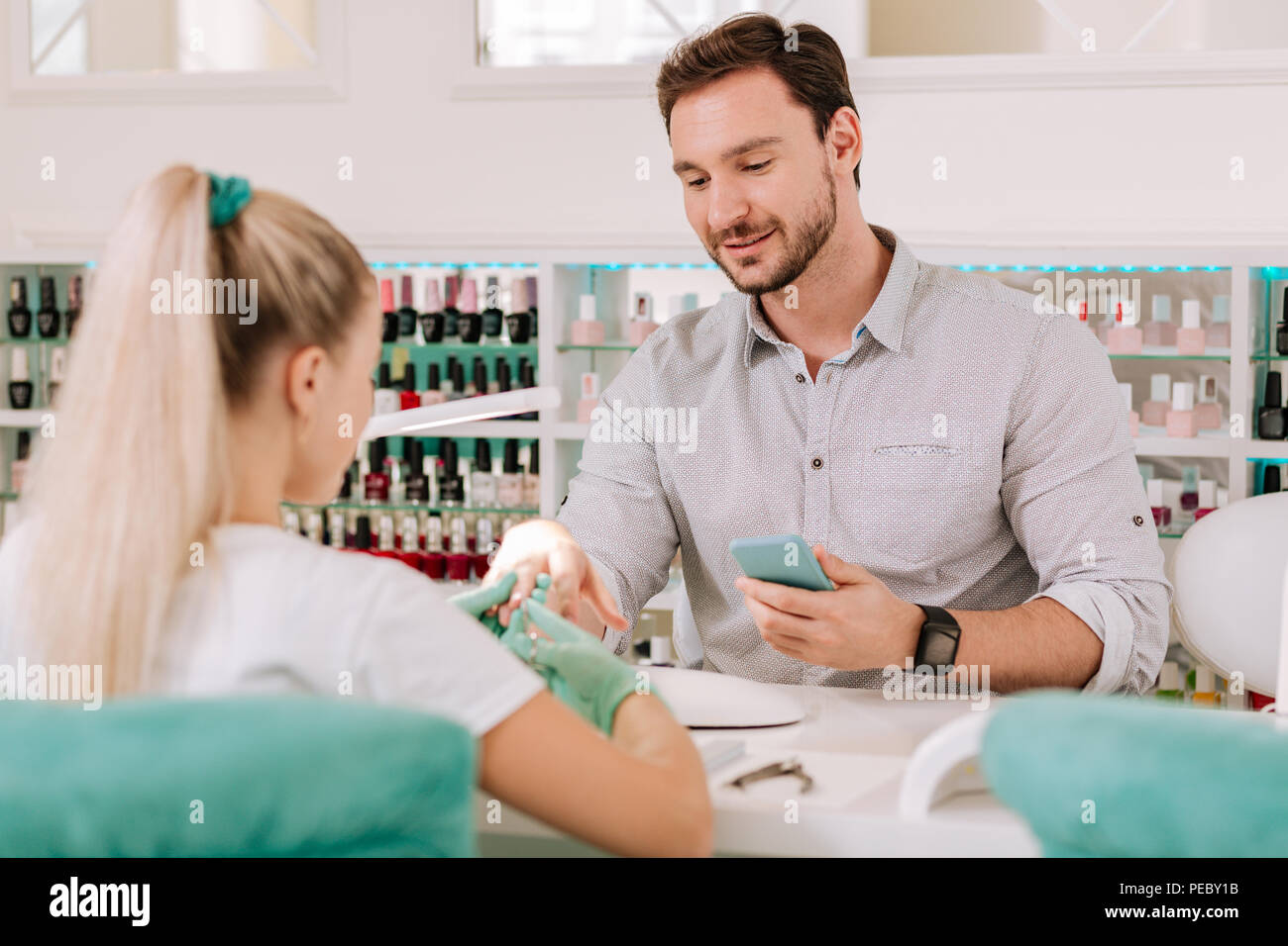 Metrosexual caring about his look getting manicure in salon Stock Photo ...