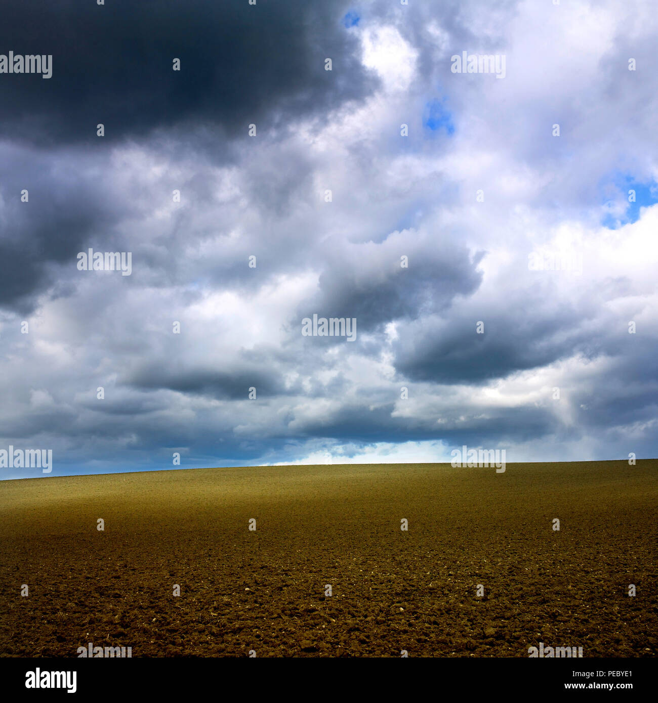 Close up on a plowed field under a cloudy and overcast sky, Auvergne ...