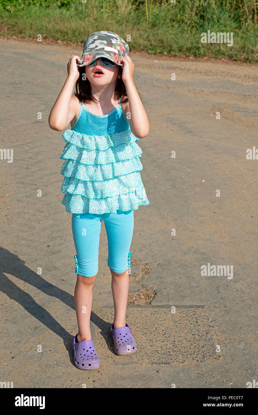 Young girl trying to keep the hot sun off her face Stock Photo - Alamy