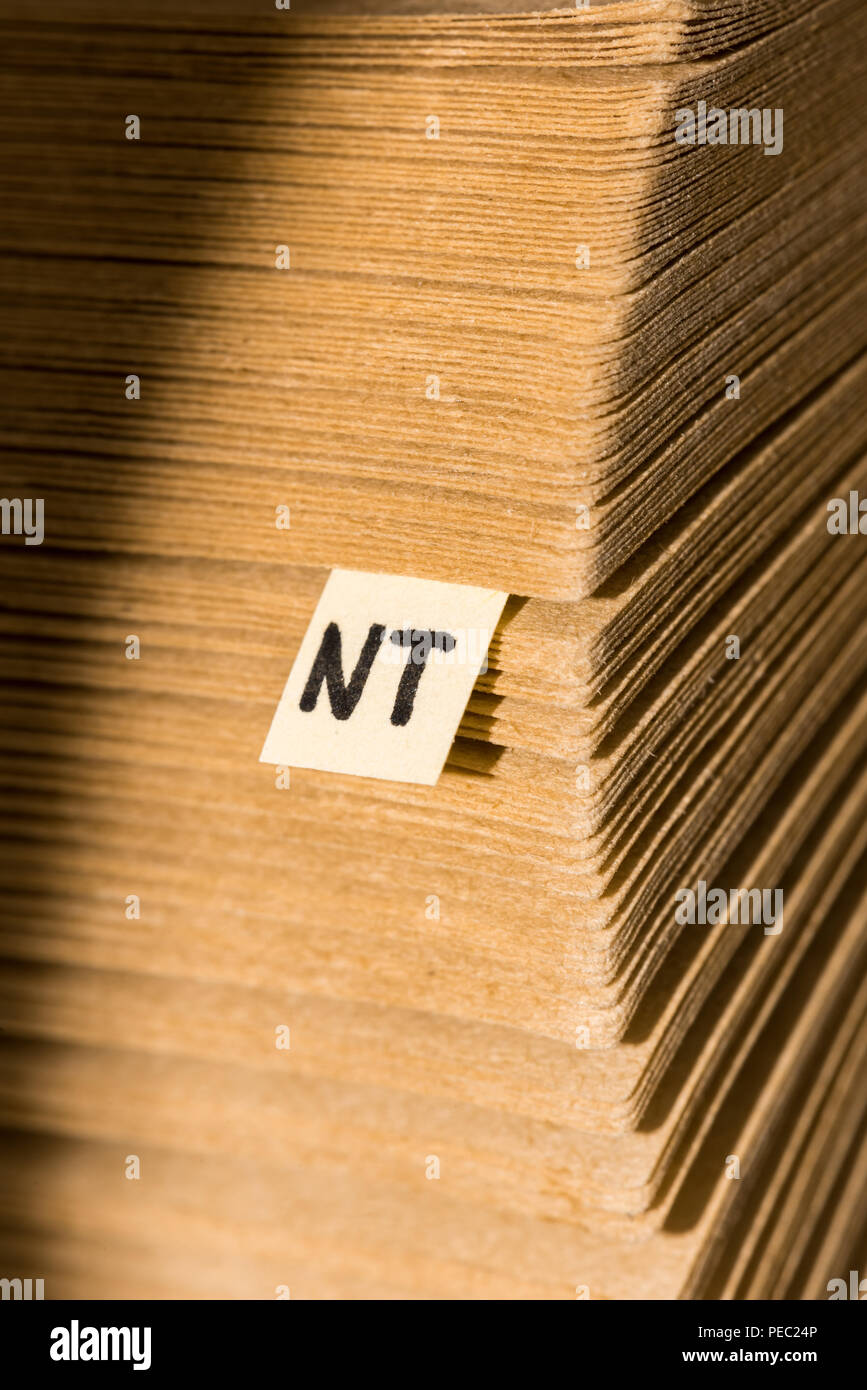 close up view of stack of cardboard papers and note with lettering nt ...