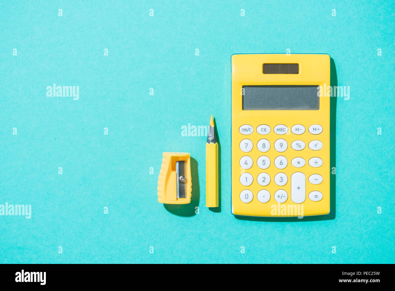 top view of arrangement of calculator, pencil and pencil sharpener on ...