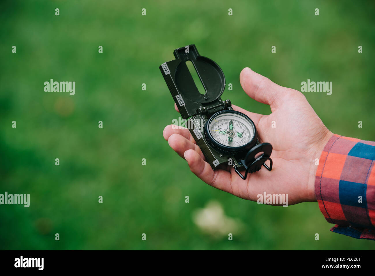 close-up partial view of man holding compass Stock Photo - Alamy