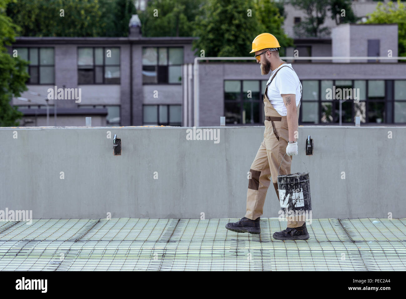 Worker carrying bucket hi-res stock photography and images - Alamy