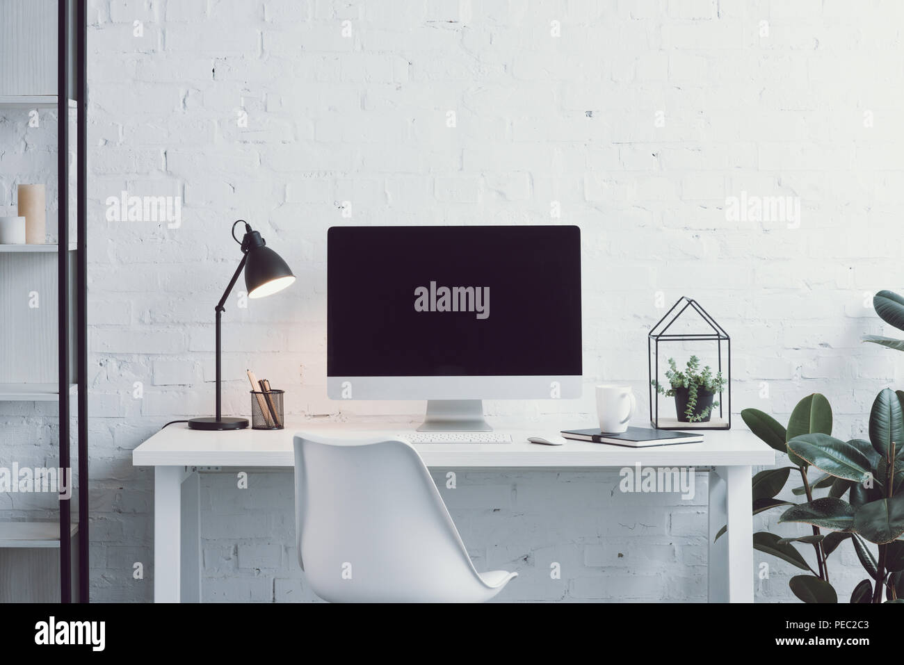 computer, white table, chair and plants in modern workplace Stock Photo ...