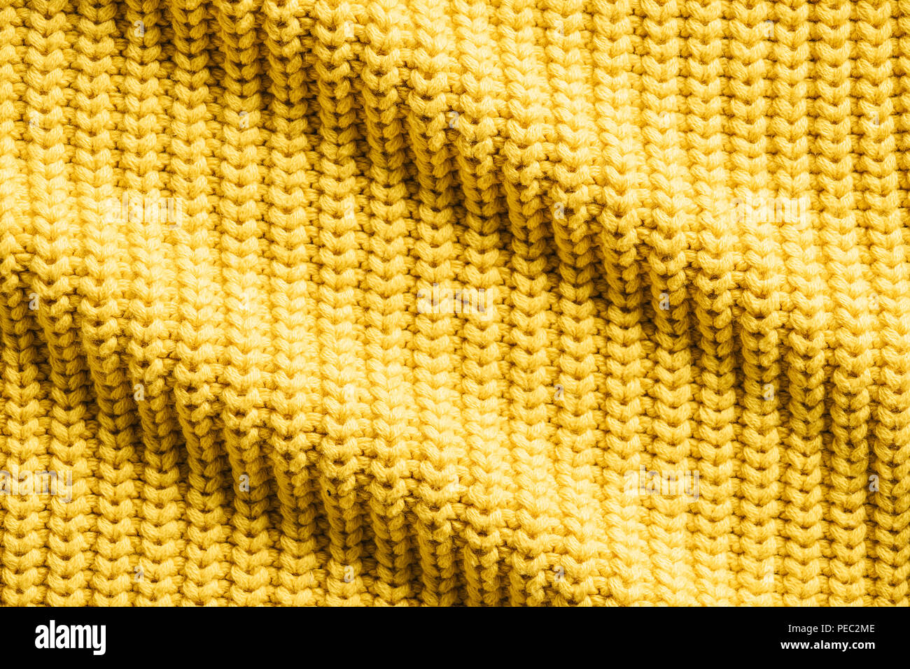 full frame image of wavy yellow woolen fabric background Stock Photo ...