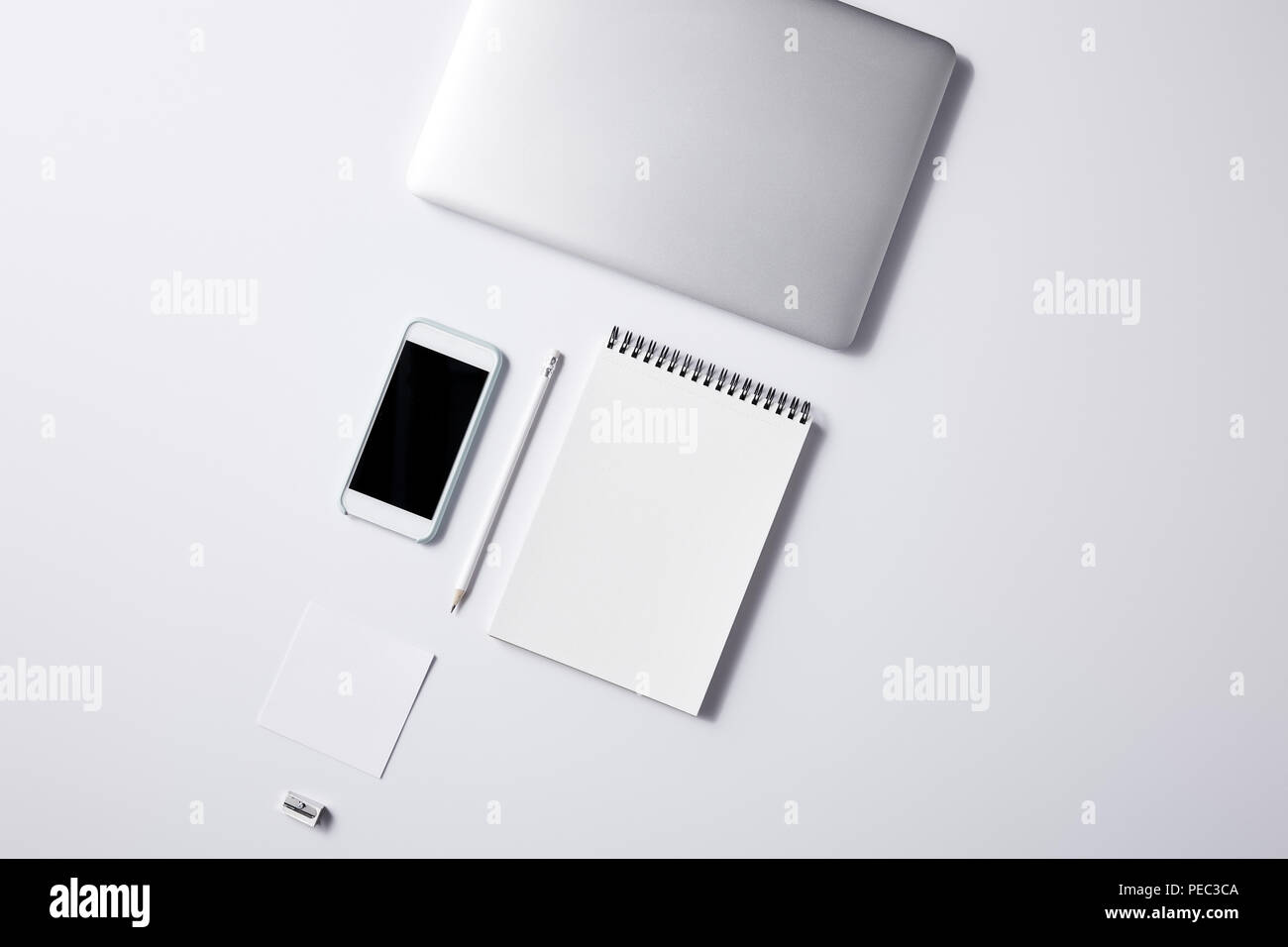 top view of arranged various business workplace objects on white ...