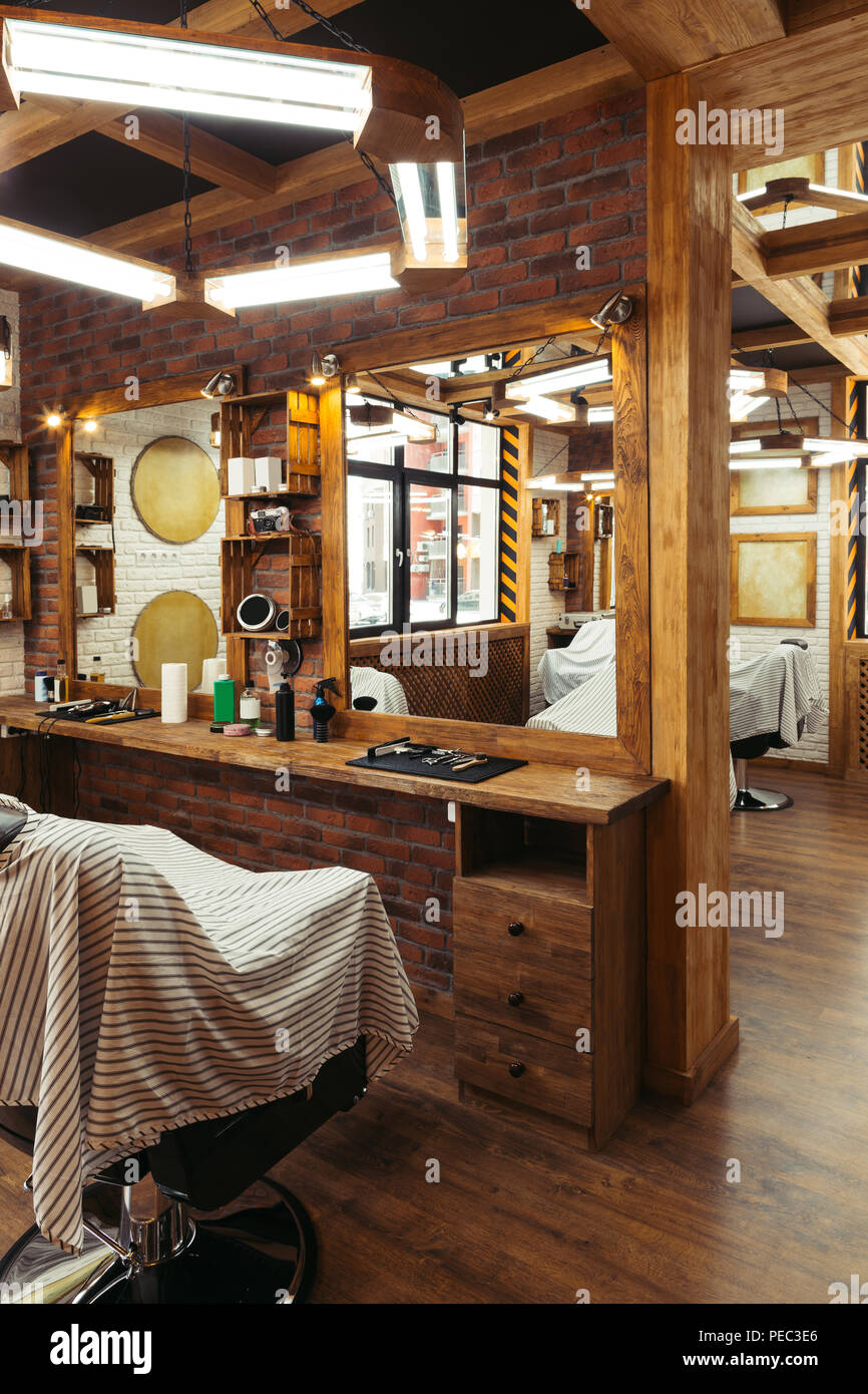 stylish illuminated barbershop with modern interior Stock Photo - Alamy
