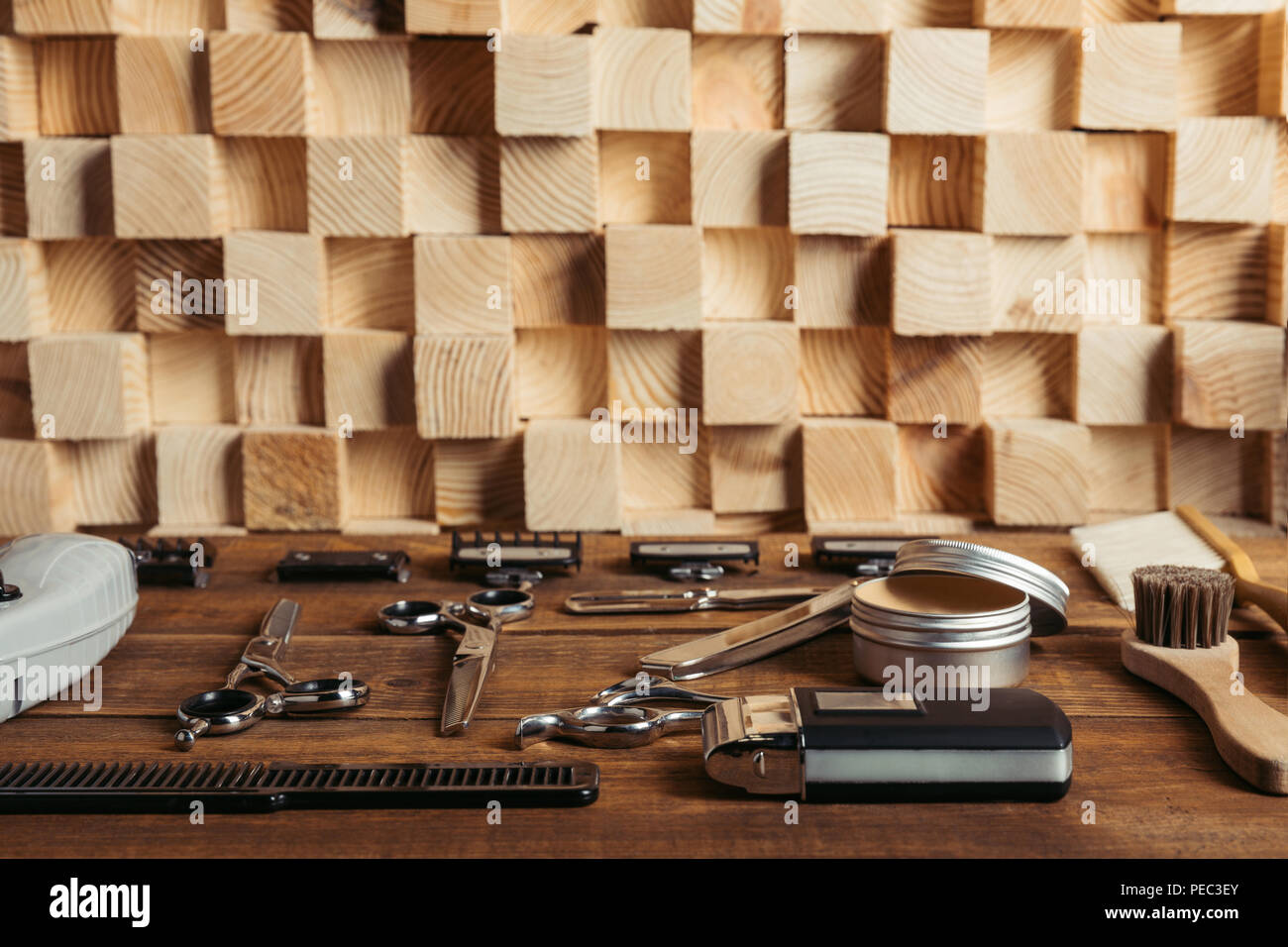 set of various professional barber tools on wooden shelf in barbershop ...