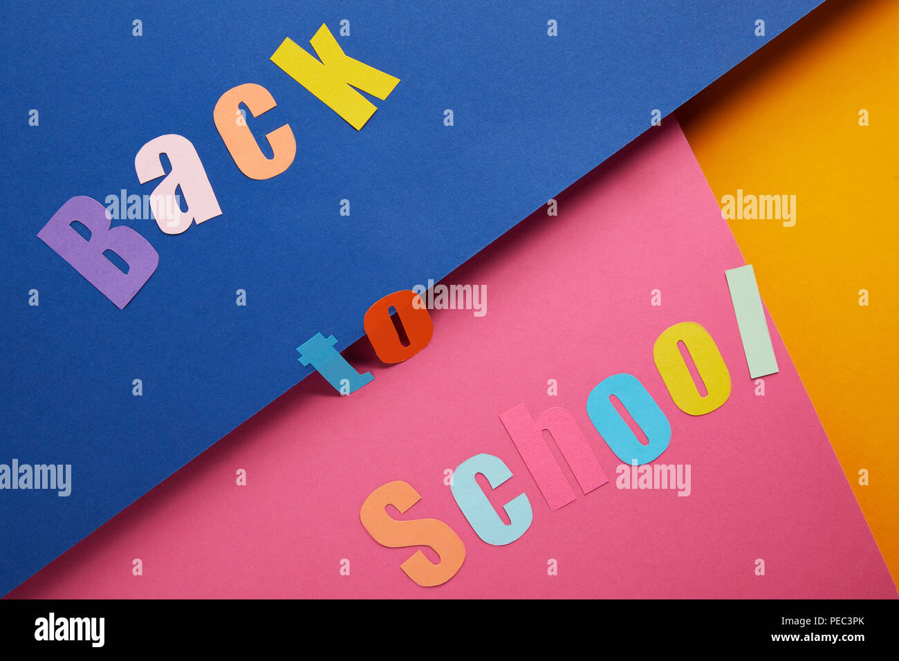 flat lay with "back to school" lettering on colorful paper background ...
