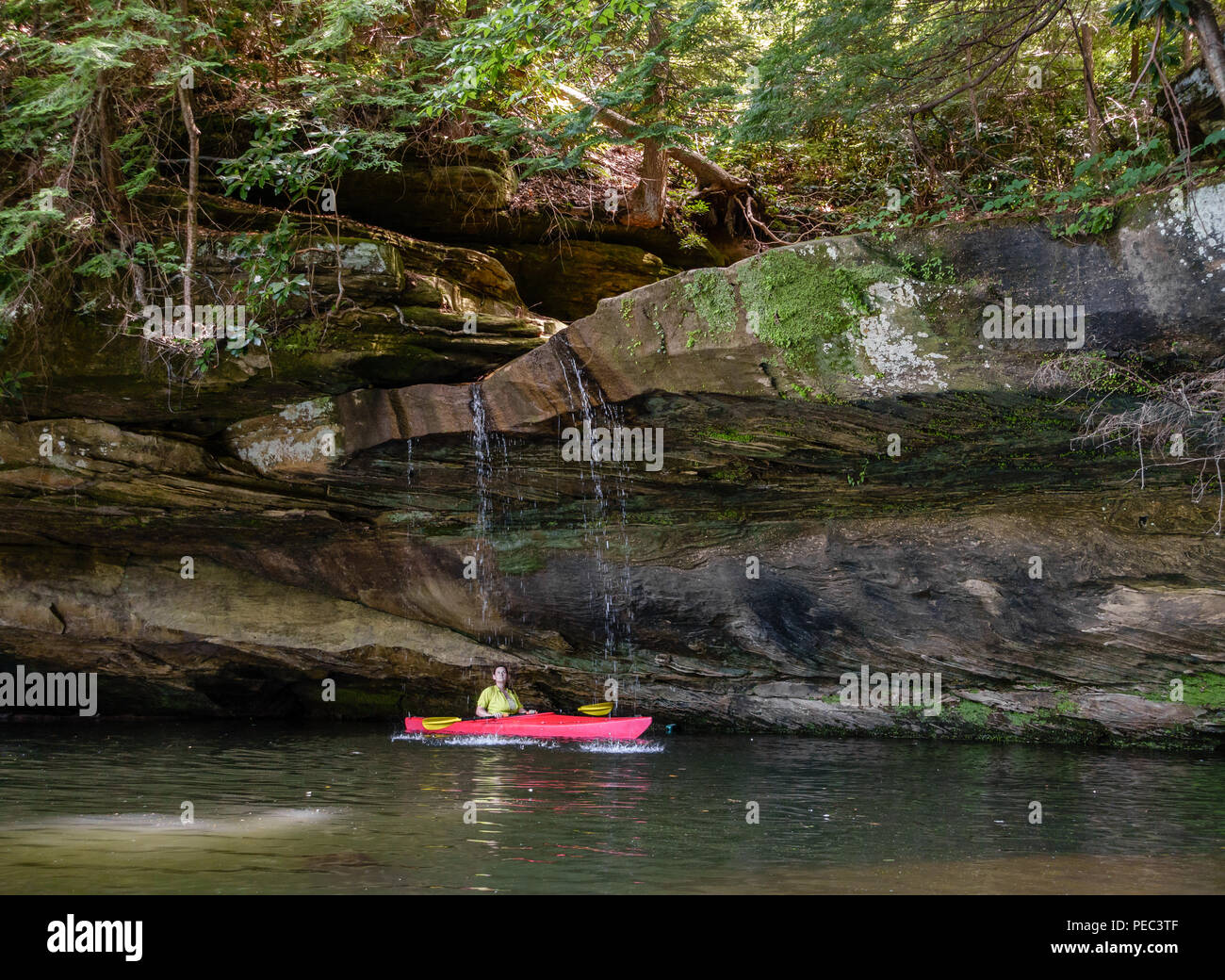 Kayaker behind a small waterfall on Grayson Lake in Kentucky Stock ...