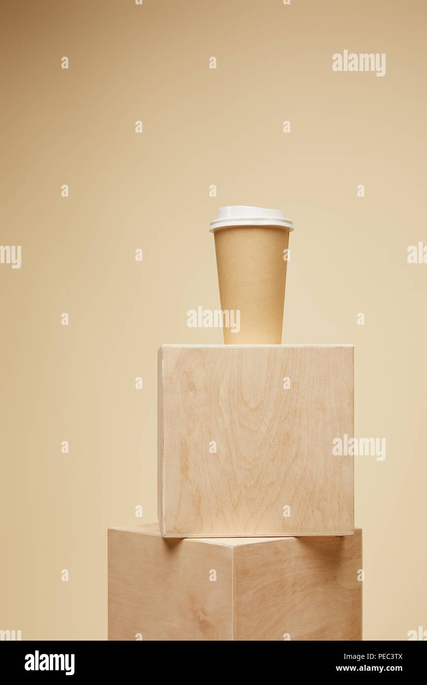 disposable coffee cup on wooden cubes isolated on beige Stock Photo - Alamy