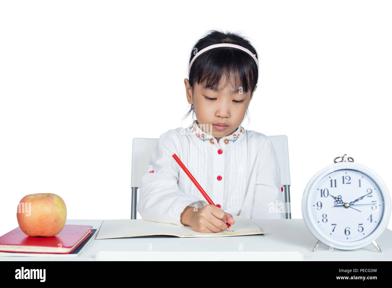 Asian Chinese Little Girl doing homework in isolated white background ...