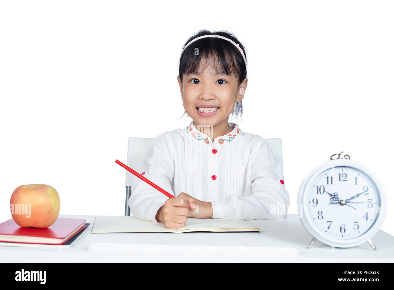 Asian Chinese Little Girl doing homework in isolated white background ...