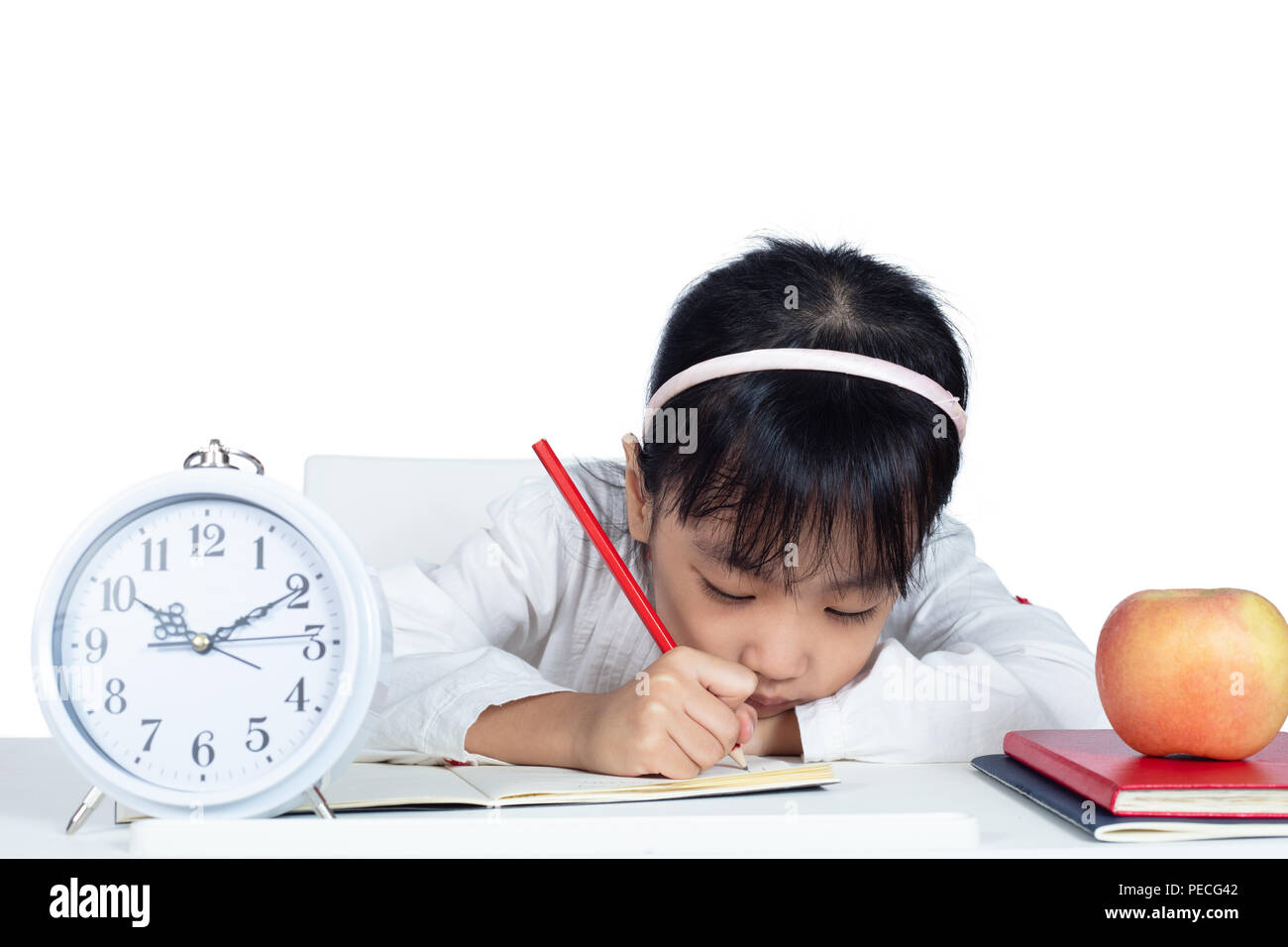 Asian Chinese Little Girl doing homework in isolated white background ...