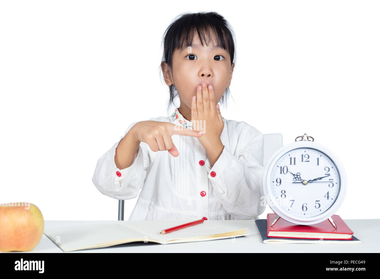 Asian Chinese Little Girl doing homework in isolated white background ...