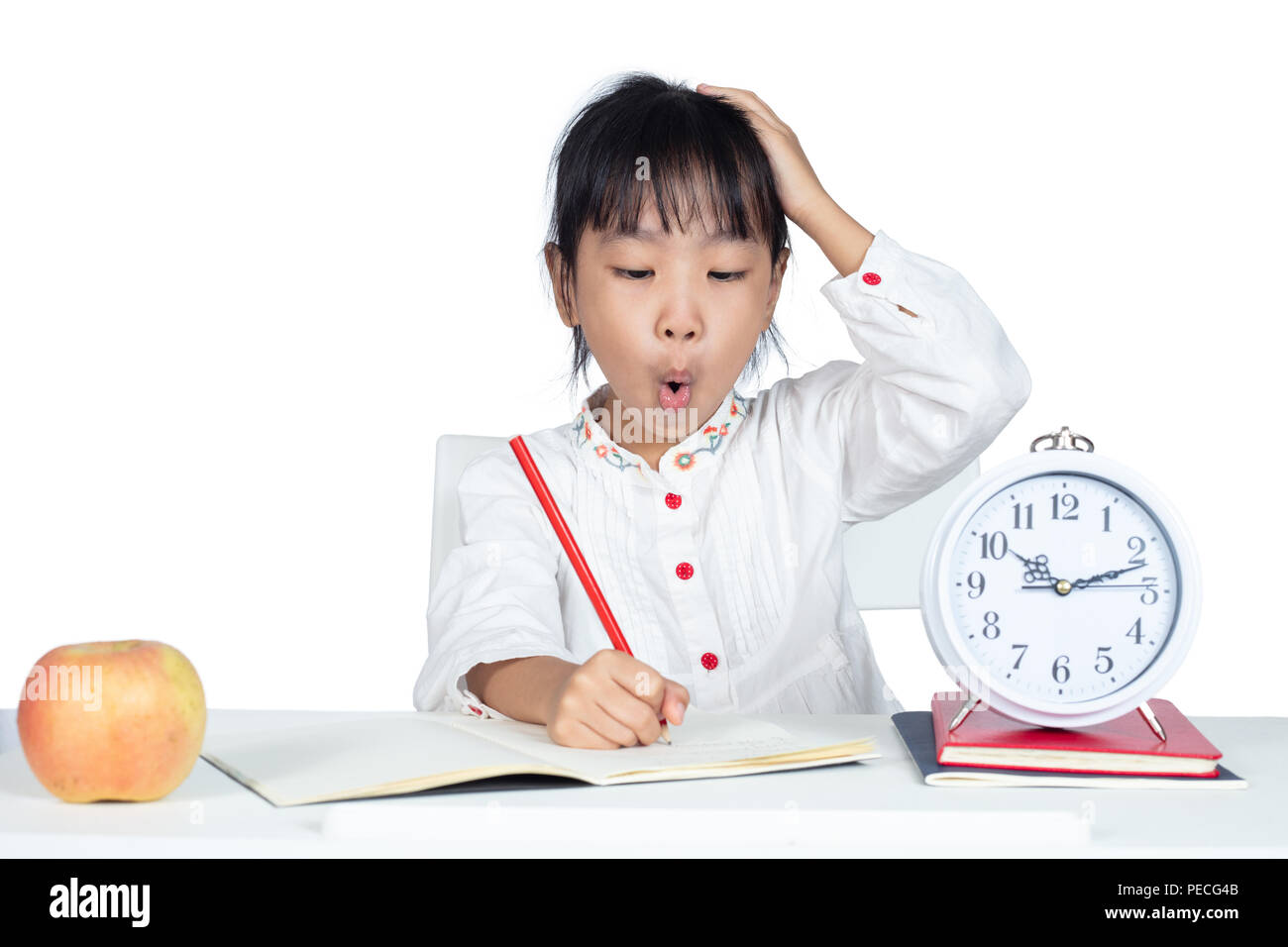 Asian Chinese Little Girl doing homework in isolated white background ...
