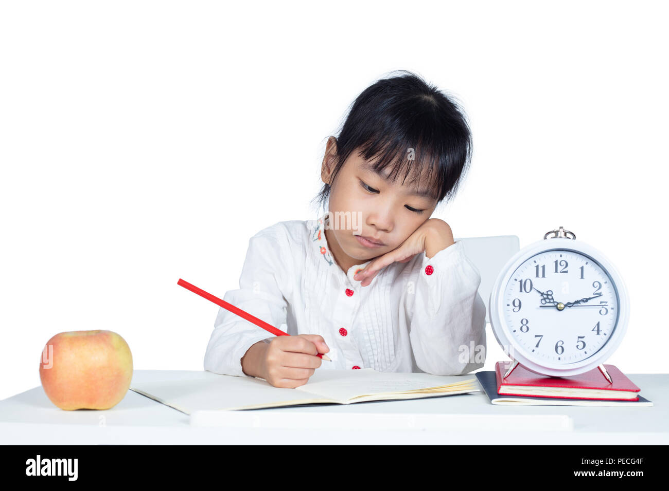 Asian Chinese Little Girl doing homework in isolated white background ...