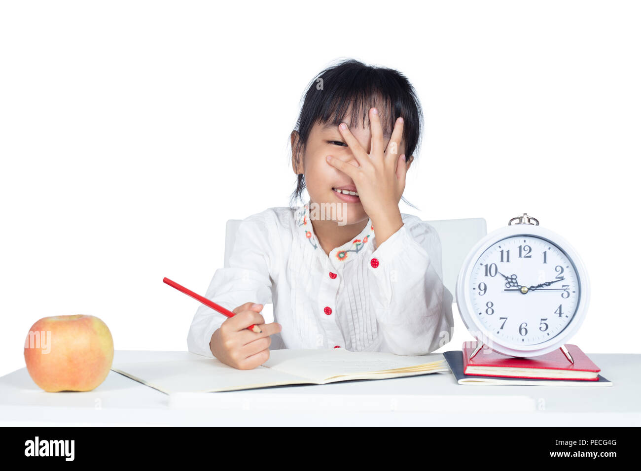 Asian Chinese Little Girl doing homework in isolated white background ...