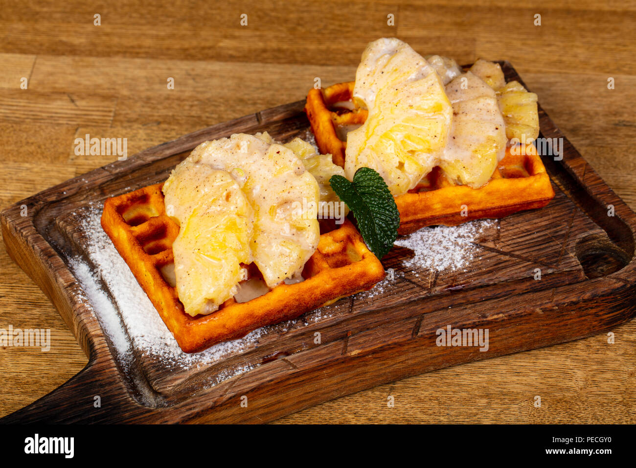Sweet Belgian Waffer over wooden background Stock Photo - Alamy