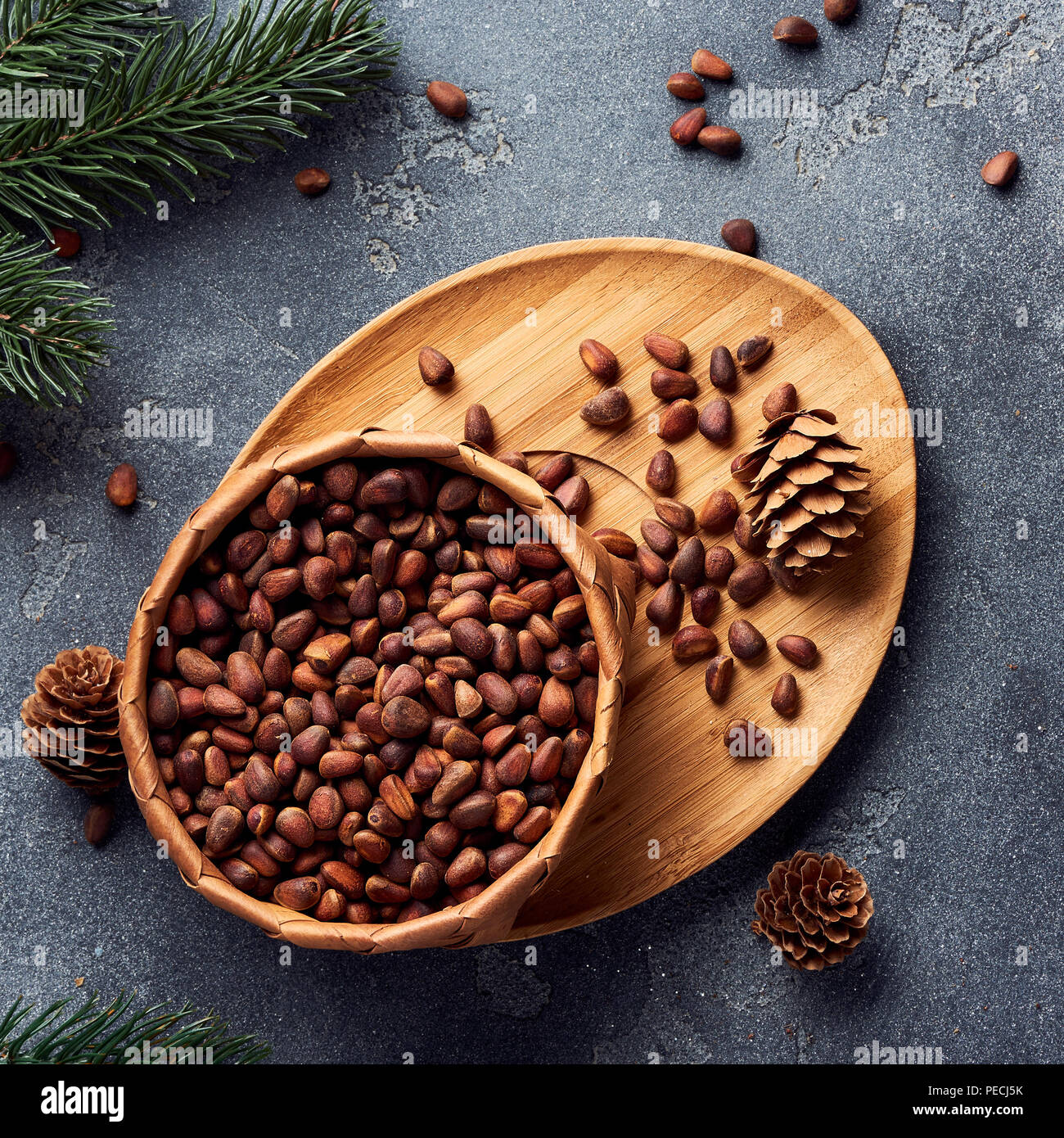 Pine nuts in bowl on gray stone table. Top view Stock Photo - Alamy