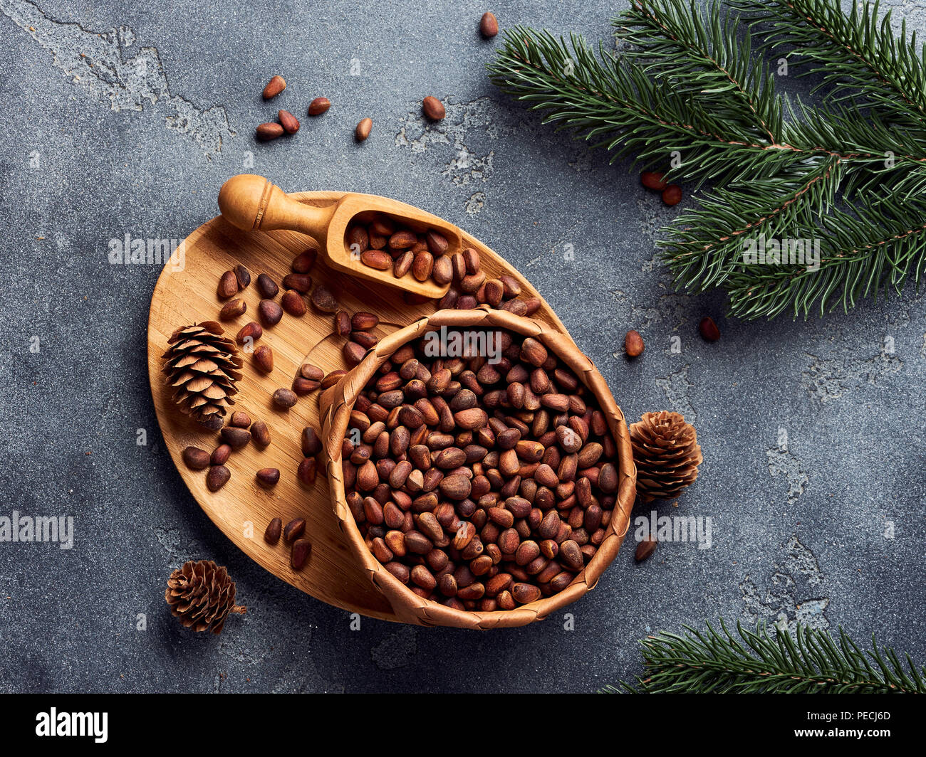 Pine nuts in bowl on gray stone table. Top view Stock Photo - Alamy