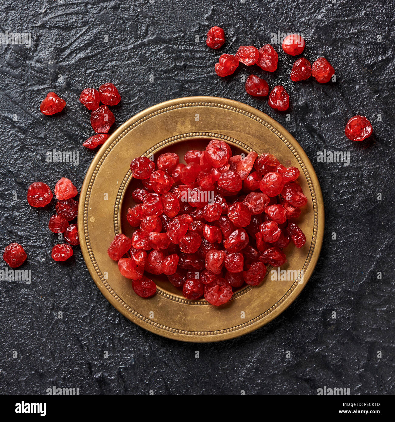 Dried red cherries on a plate. Top view Stock Photo - Alamy