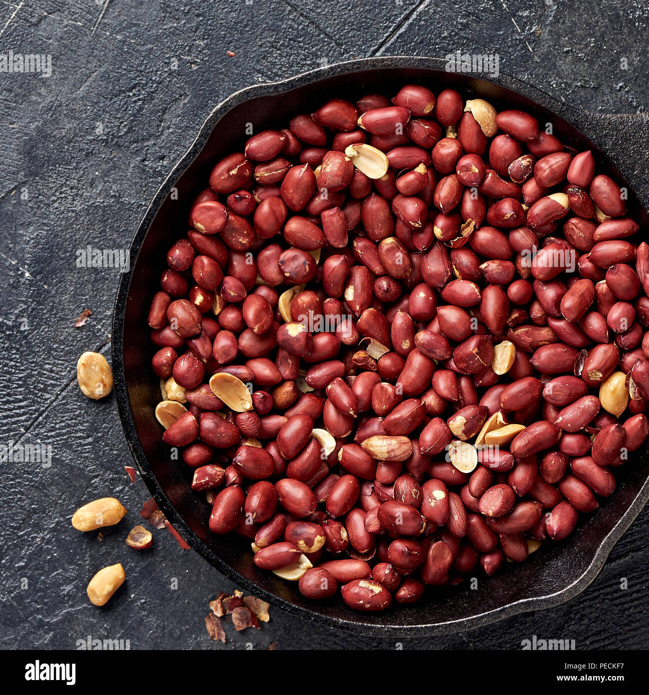 Fried peanut in pan on black background. Top view Stock Photo - Alamy