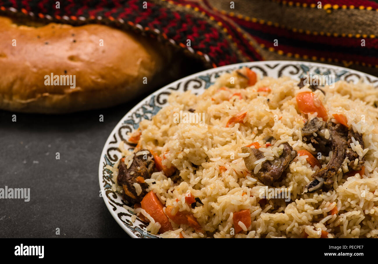 Pilaf on plate with oriental ornament and Traditional Asian breads ...